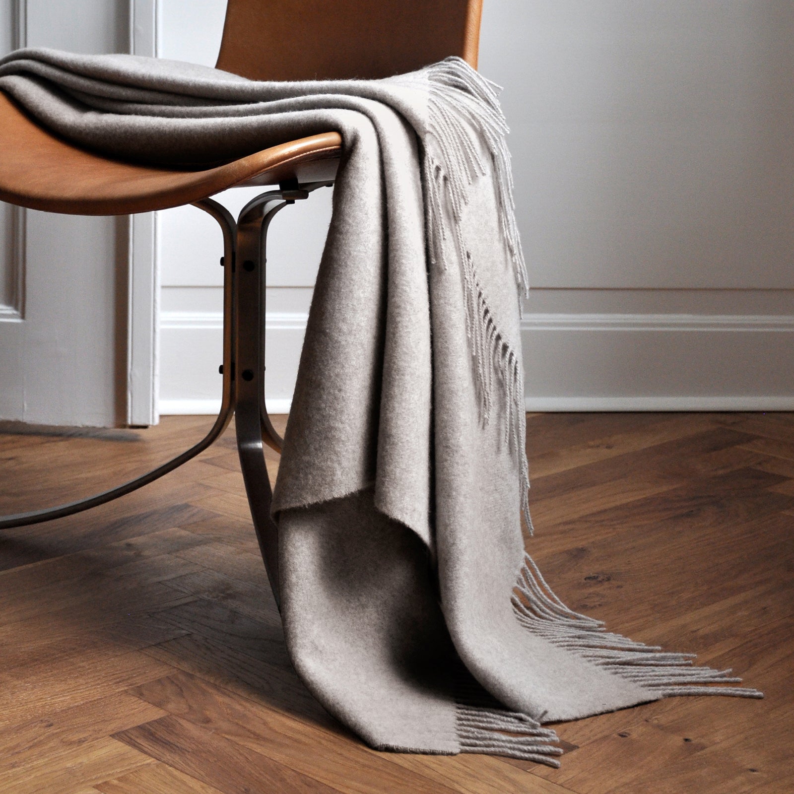 Sand coloured throw in classic design